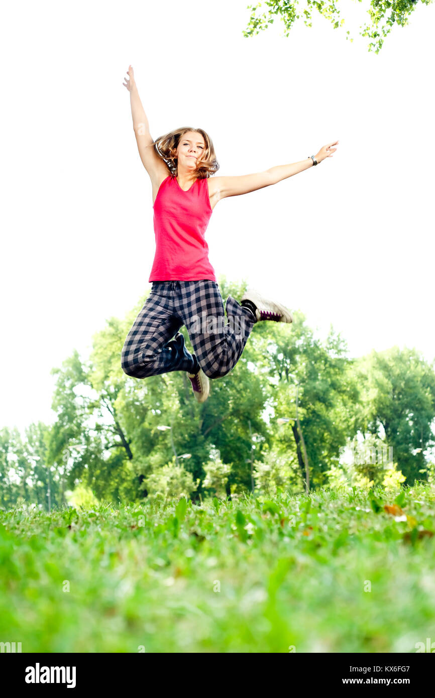 beautiful young girl jumping in the park Stock Photo - Alamy