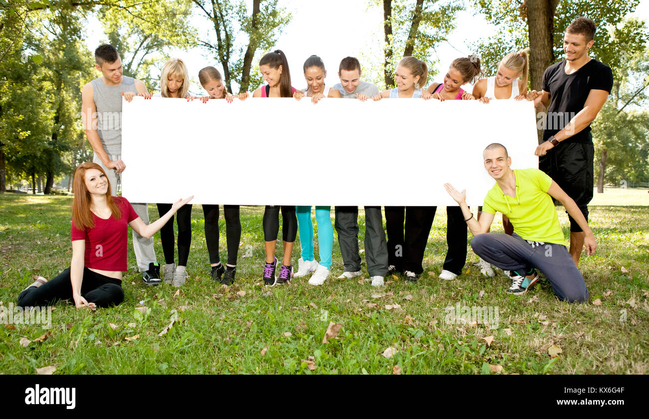 group of students with big blank paper in park Stock Photo - Alamy