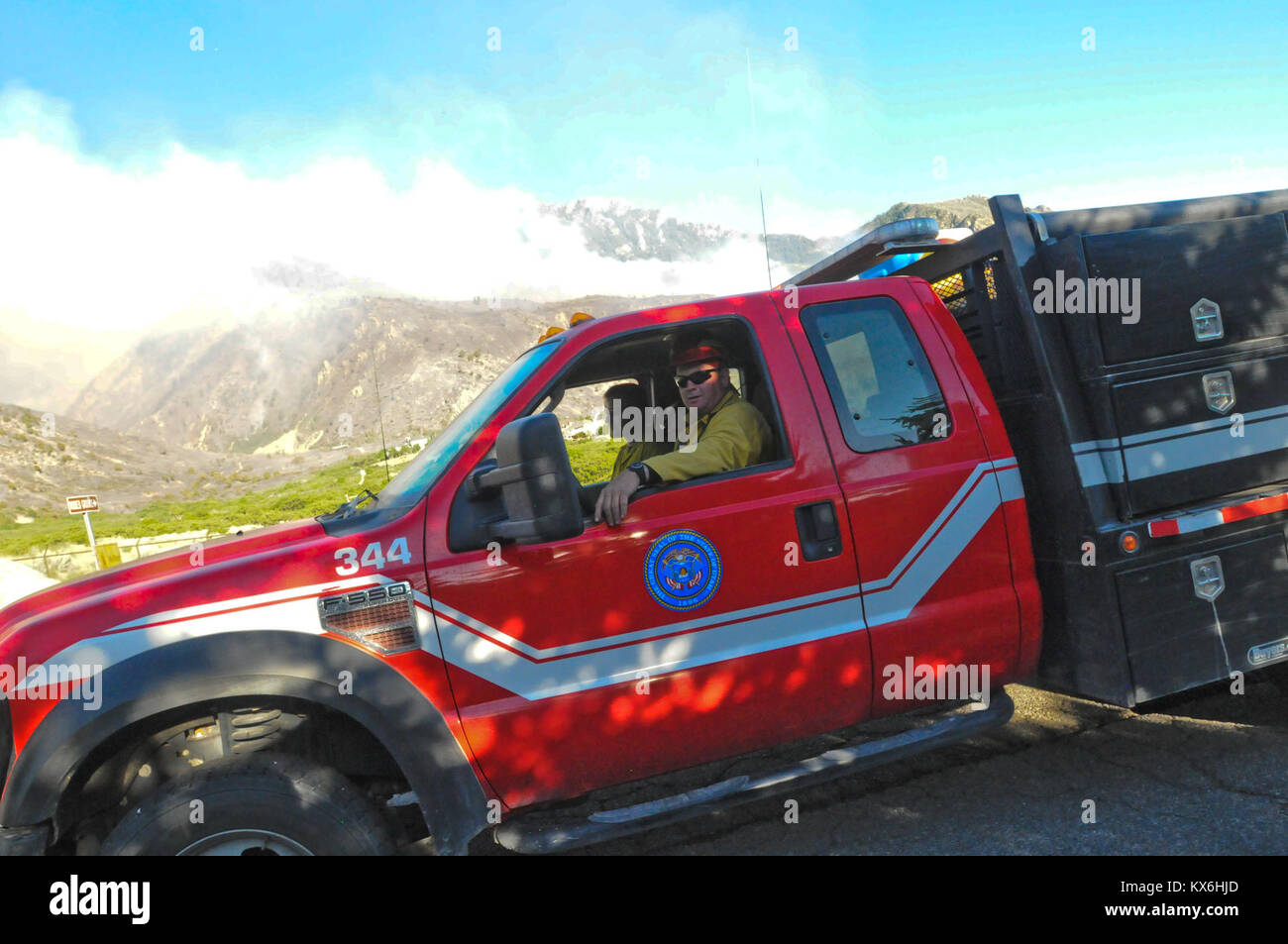 A firefighting crew from Camp Williams, Utah, drives a road in Alpine ...