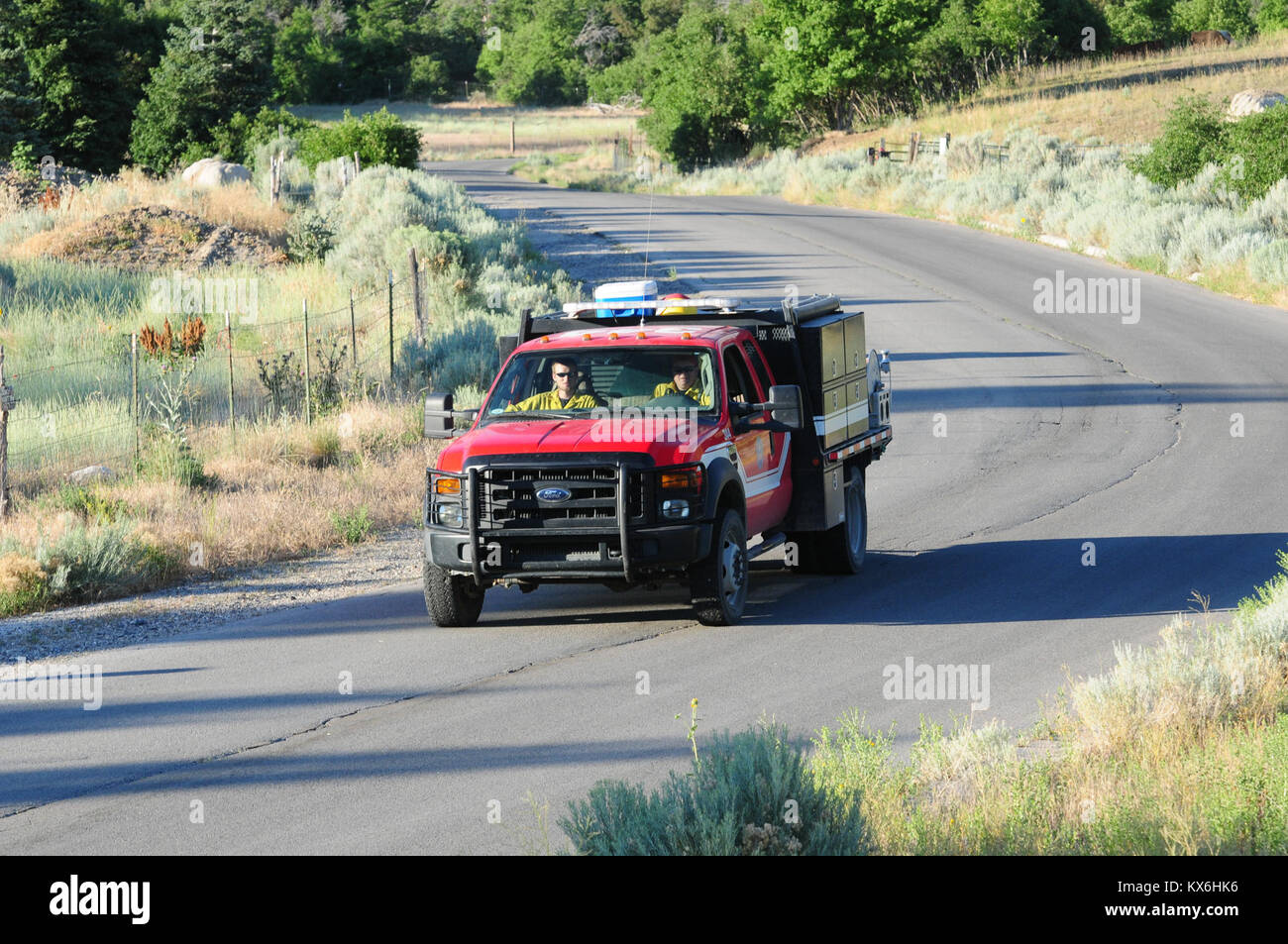A firefighting crew from Camp Williams, Utah, drives a road in Alpine ...