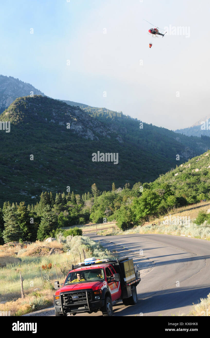 A firefighting crew from Camp Williams, Utah, drives a road in Alpine ...