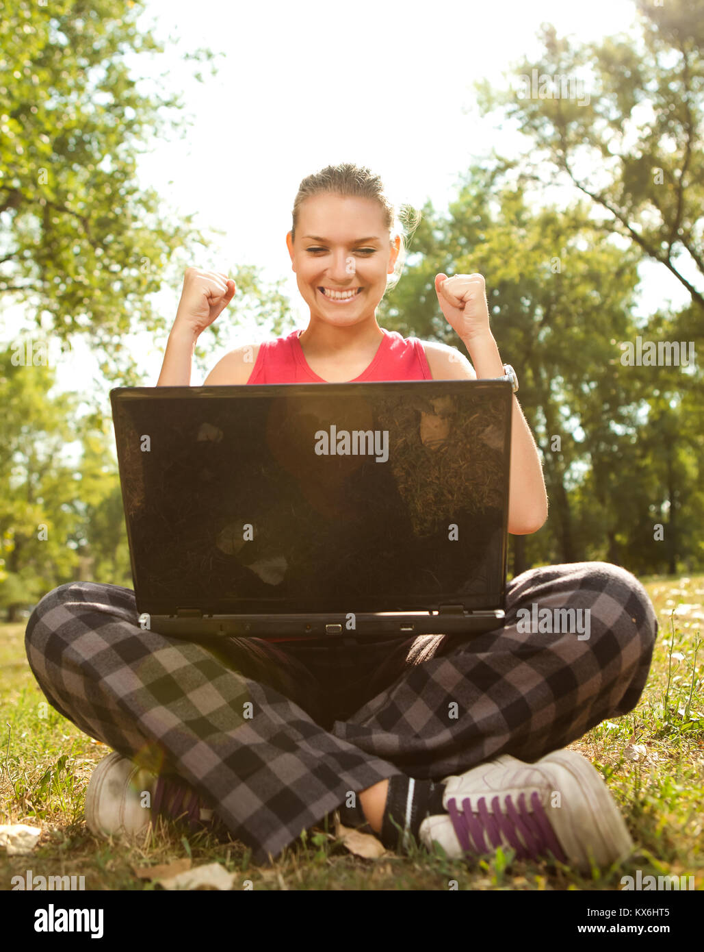 victory girl with laptop outdoor with raised hands Stock Photo - Alamy