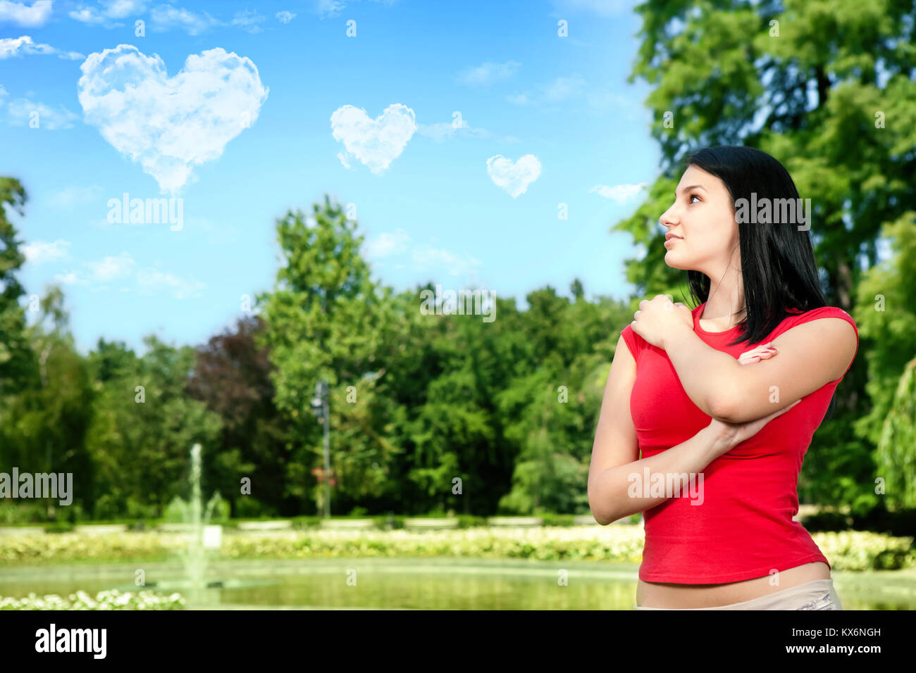 young woman in love looking in heart shaped cloud Stock Photo - Alamy