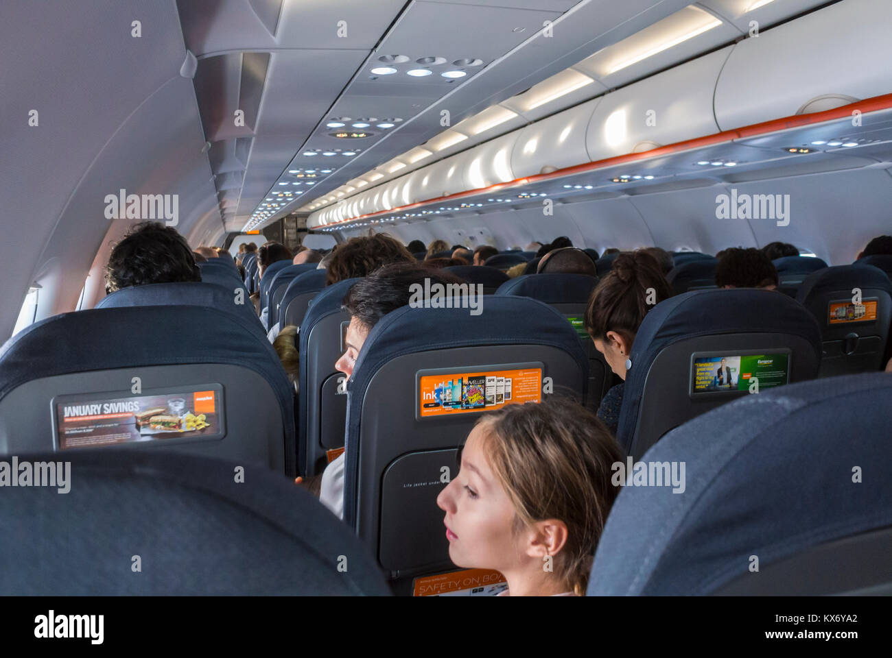 Passengers on plane rear view hi-res stock photography and images - Alamy