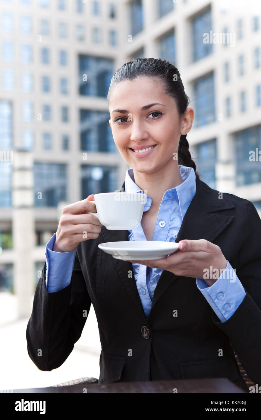 smiling business lady drinking coffee in business center Stock Photo ...