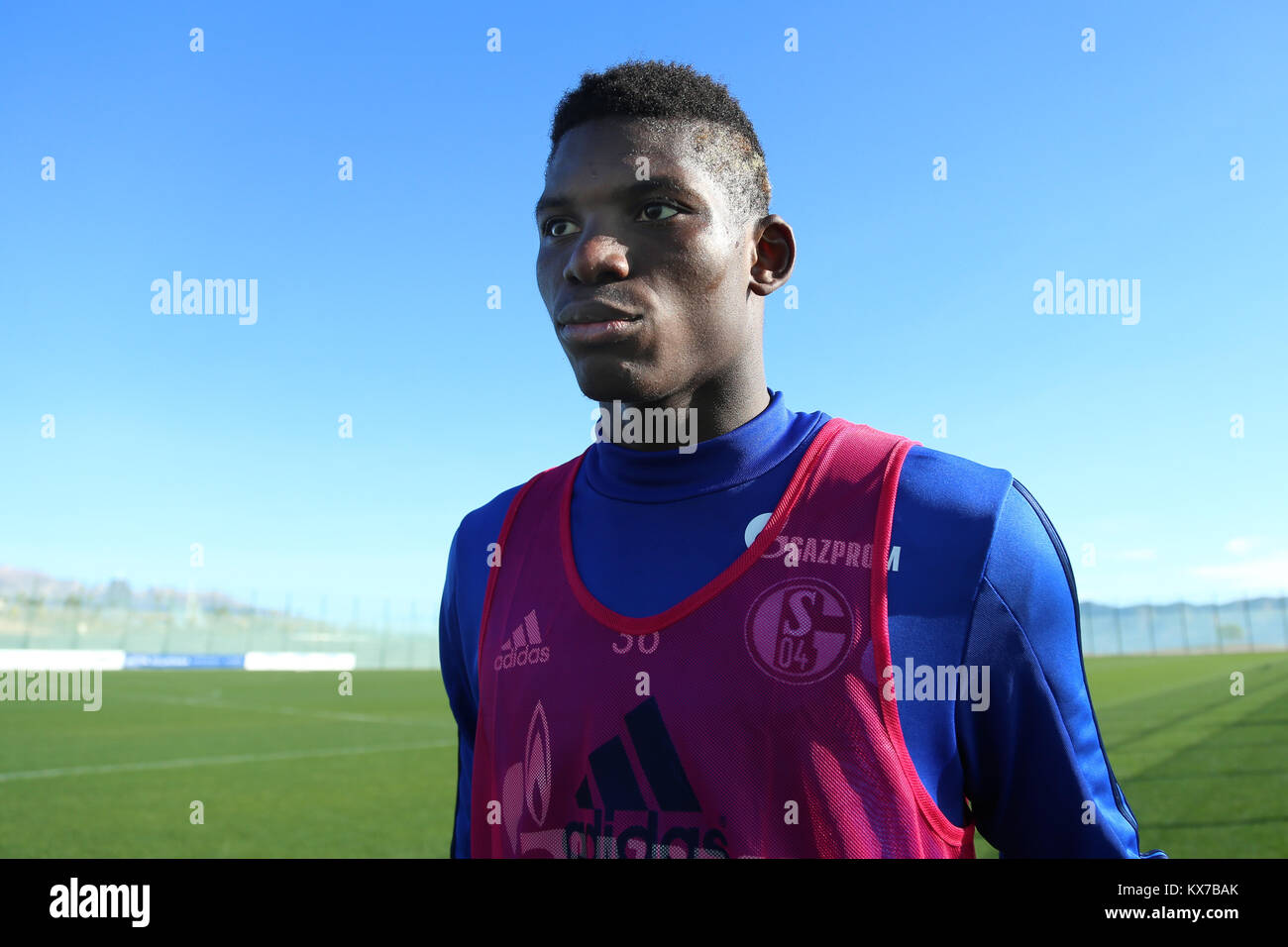 Schalke's Breel Embolo stands in front of the pitch at the winter ...