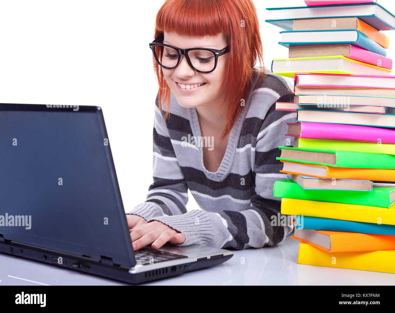 smiling girl with stack color book and laptop, isolated on white ...