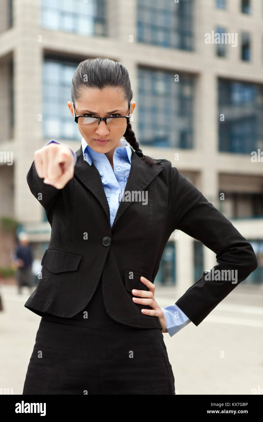 angry business woman as boss, in front of office buildings Stock Photo ...