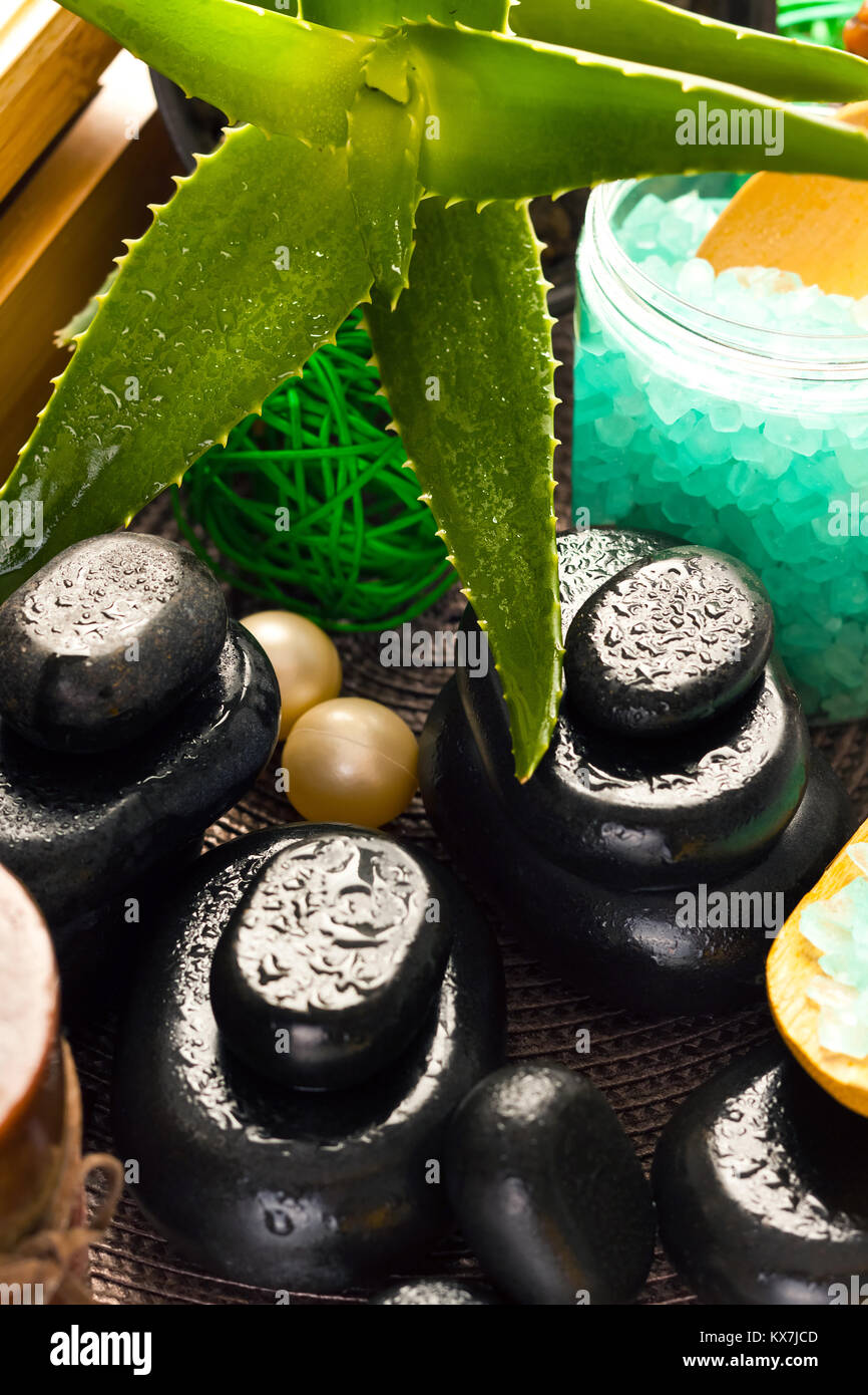 spa treatment, massage stones and aloe vera Stock Photo - Alamy