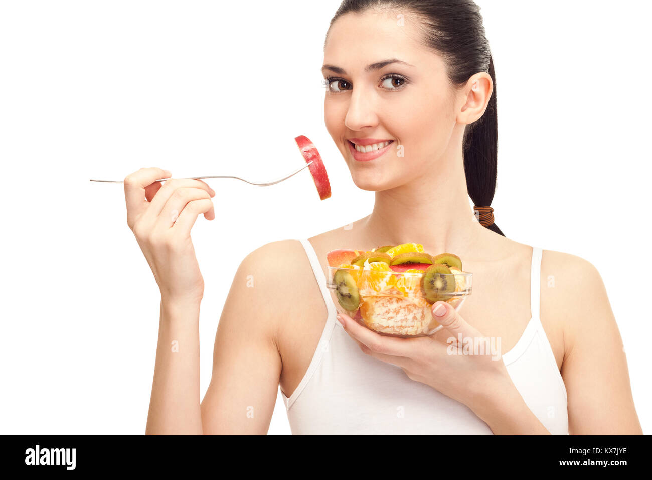 close up of a pretty young lady eating fruit salad, isolated on white ...
