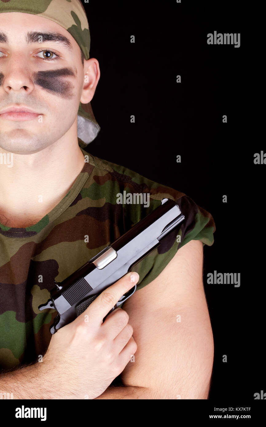 young handsome soldier posing with gun on black background Stock Photo ...