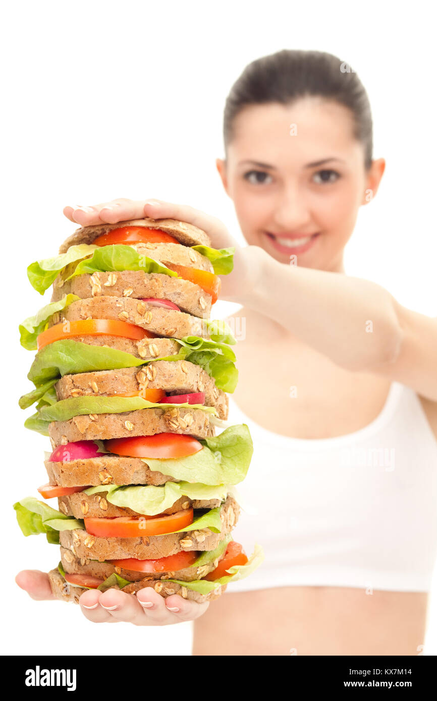 pretty, smiling young woman giving us a huge sandwich, isolated on ...
