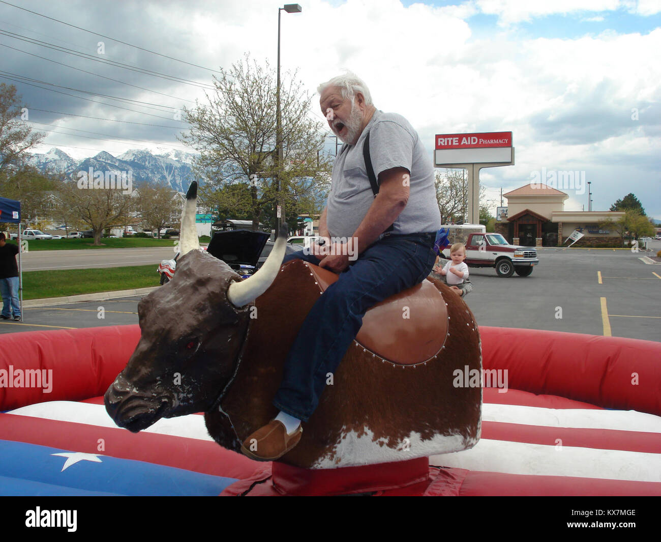 A visitor gives the mechanical bull a try at the new Utah Army National ...