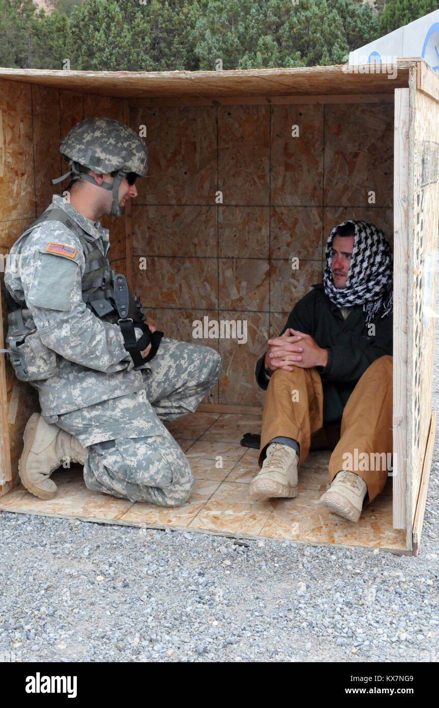 A human intelligence collector speaks to a role player during an ...