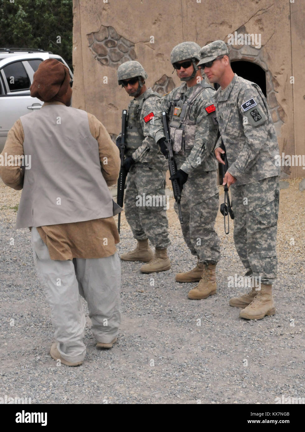 Human intelligence collectors speak to a role player during an ...