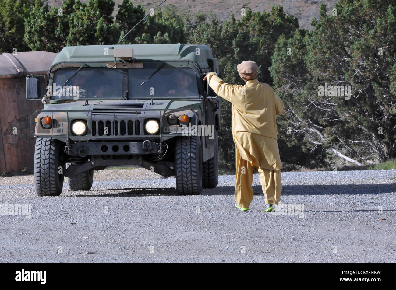 A role player flags down a Humvee during an intelligence-gathering ...