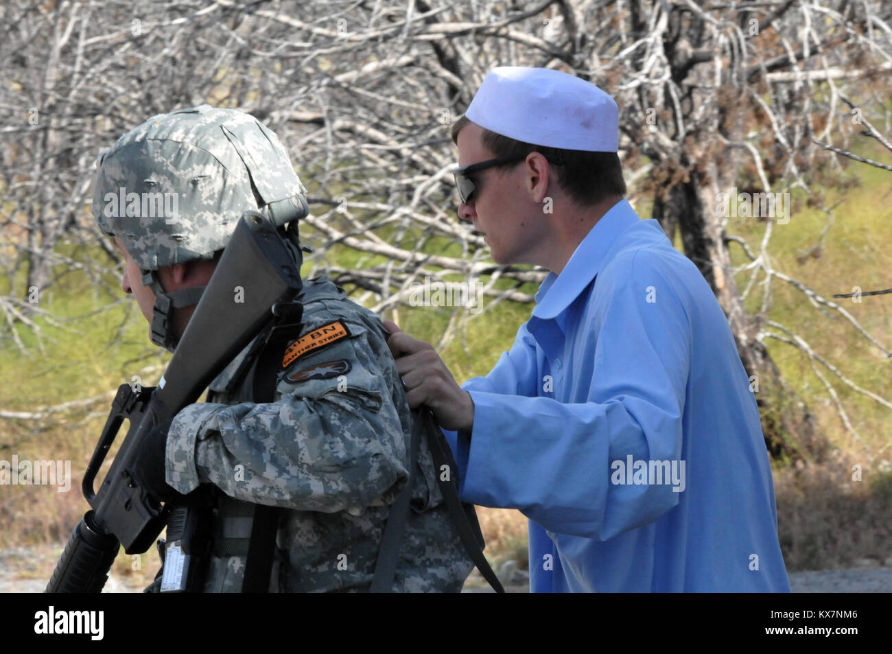 A human intelligence collector leads a role player to a safer place to ...