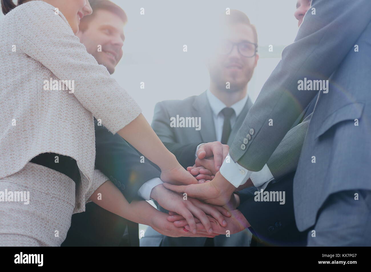 Business team joining hands together Stock Photo - Alamy