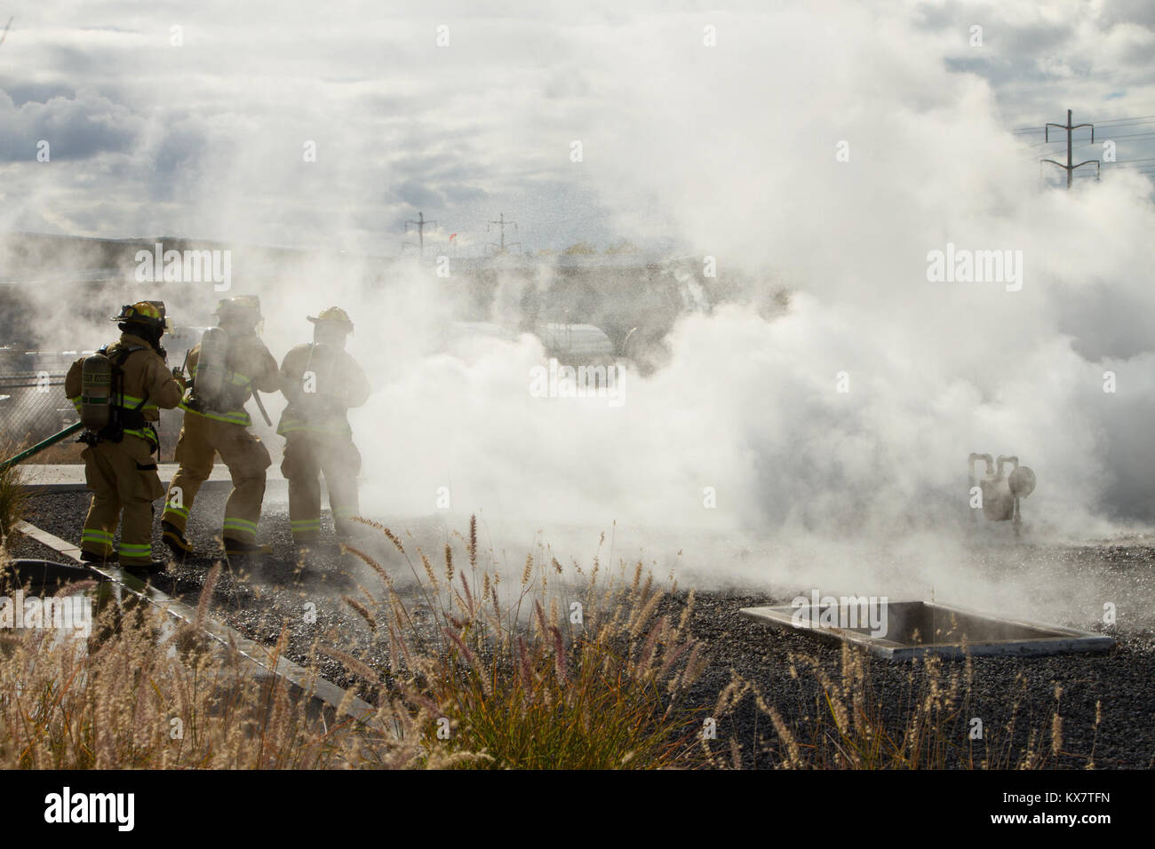 Three members of the 151st Fire Department UTANG put out a simulated ...