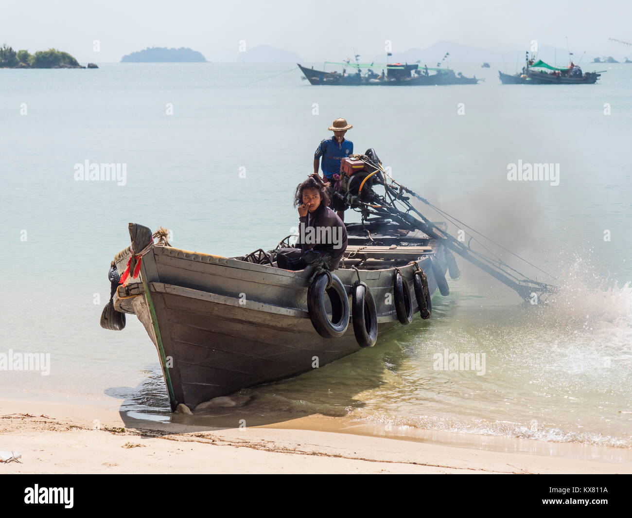 Islanders and their boat at Dome Island outside Myeik, a part of the ...