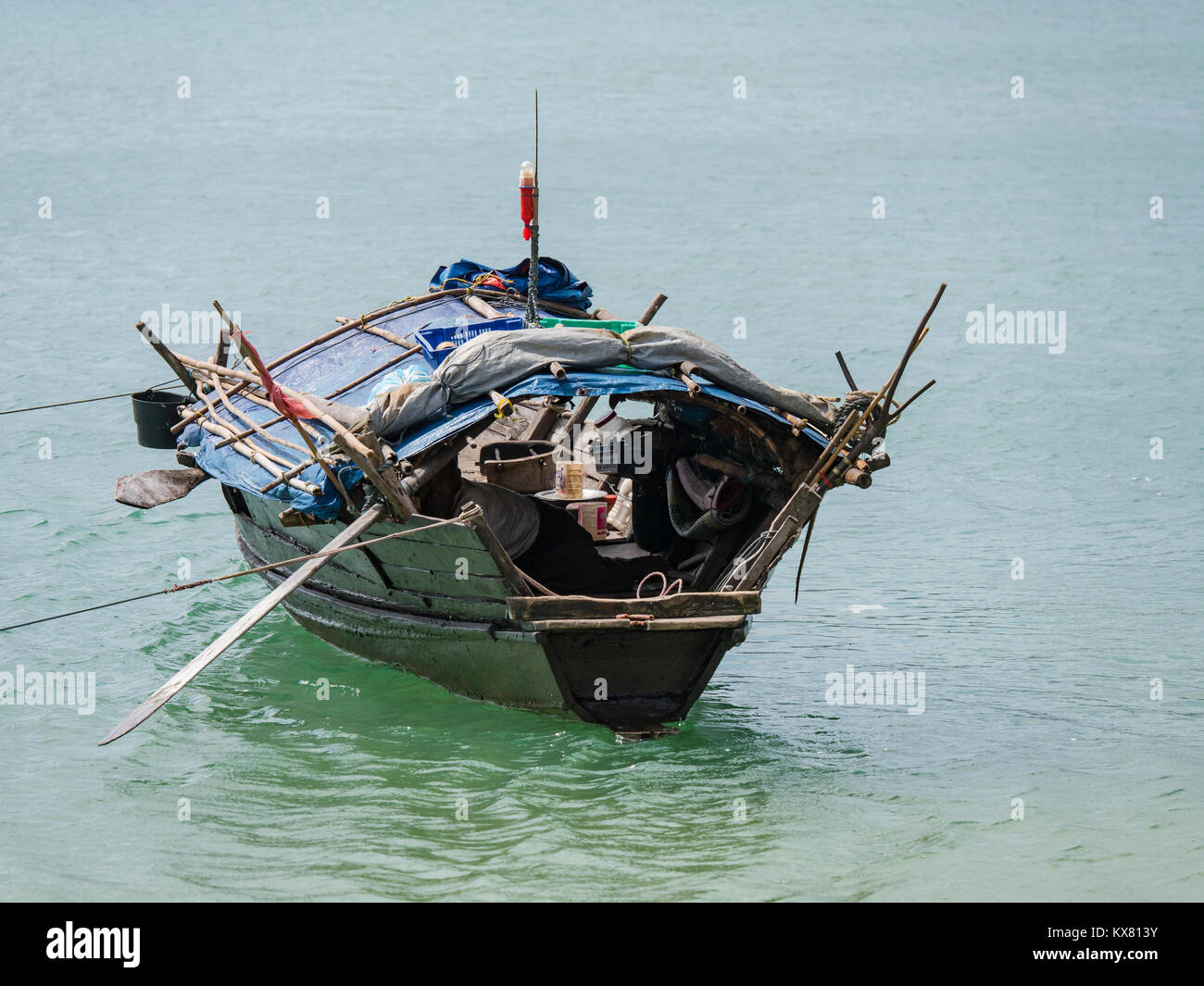 A Moken sea gypsy and his boat at Dome Island outside Myeik, a part of ...