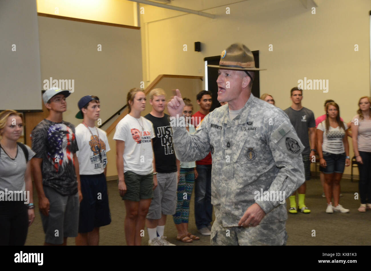 US Army National Guard event with young people, drill sergeant shouts ...