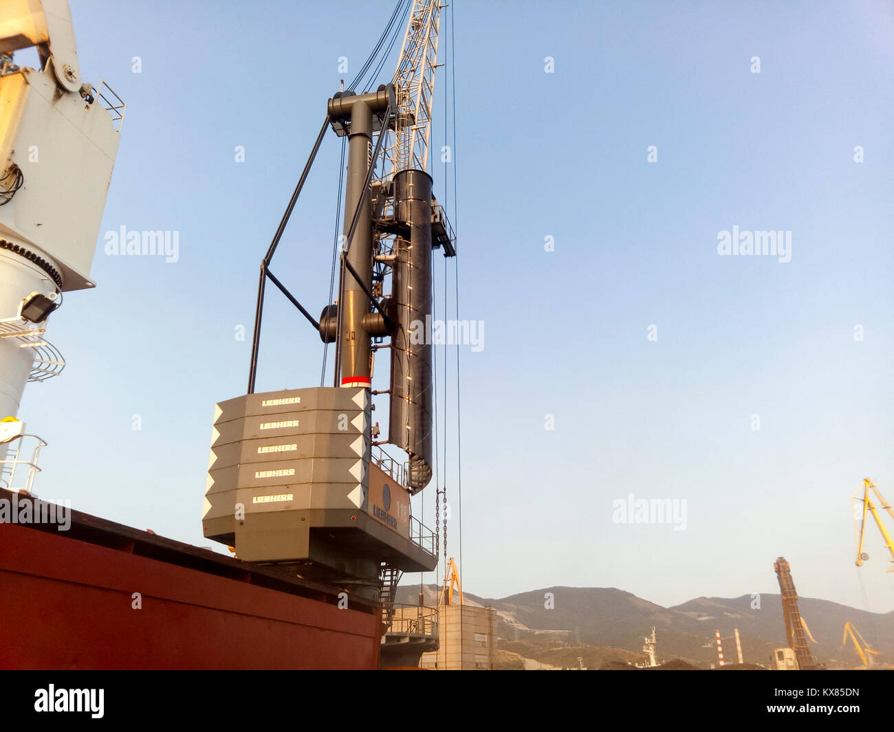 Crane on a cargo ship in the port Stock Photo - Alamy