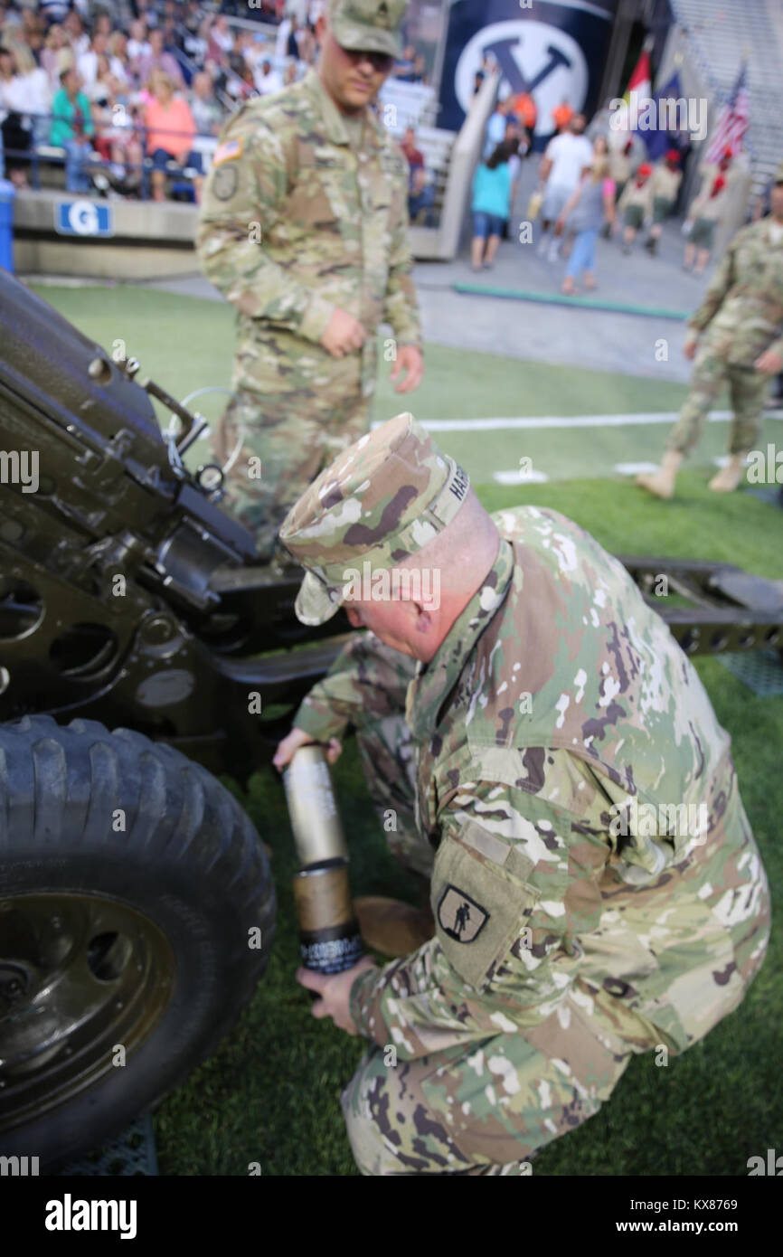 US Army National Guard soldier loading howitzer at ceremonial event ...
