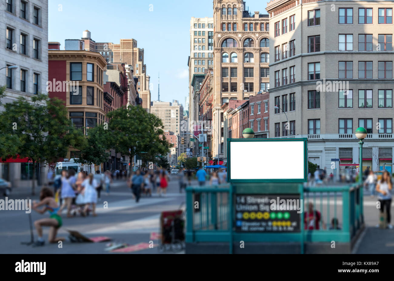 Crowd of anonymous people walking around a blank billboard sign in ...