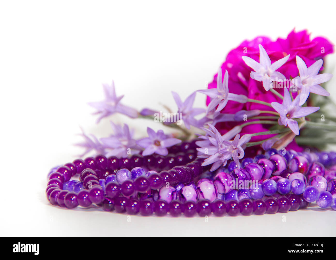 feminine and romantic pearls and flowers in violet tone Stock Photo - Alamy