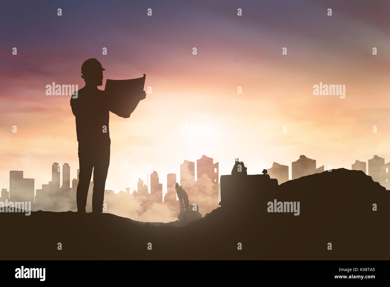 Silhouette of engineer man looking his blueprint in construction site ...