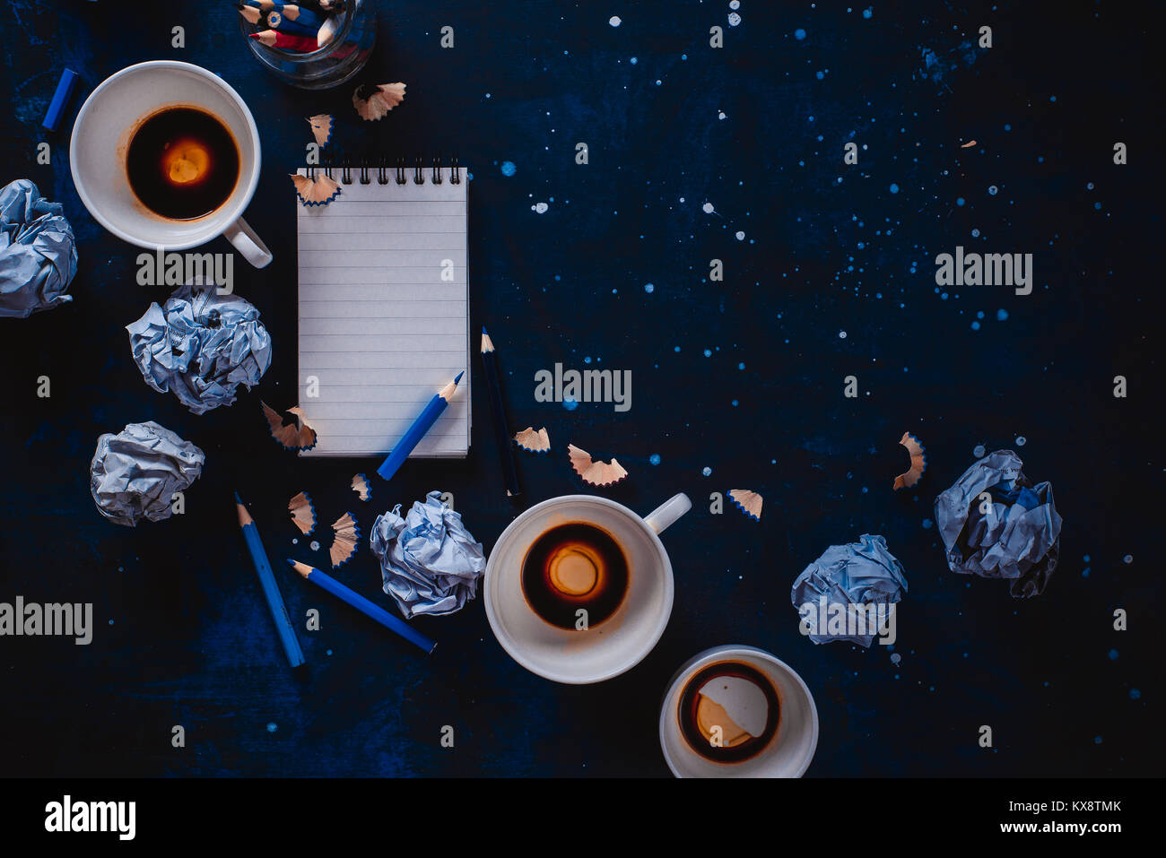 Creative writing concept with linded note paper, empty coffee cups ...