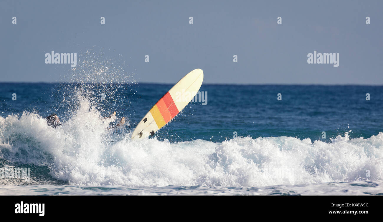 Surfer legs in water and surfing board in the air after falling a wave ...