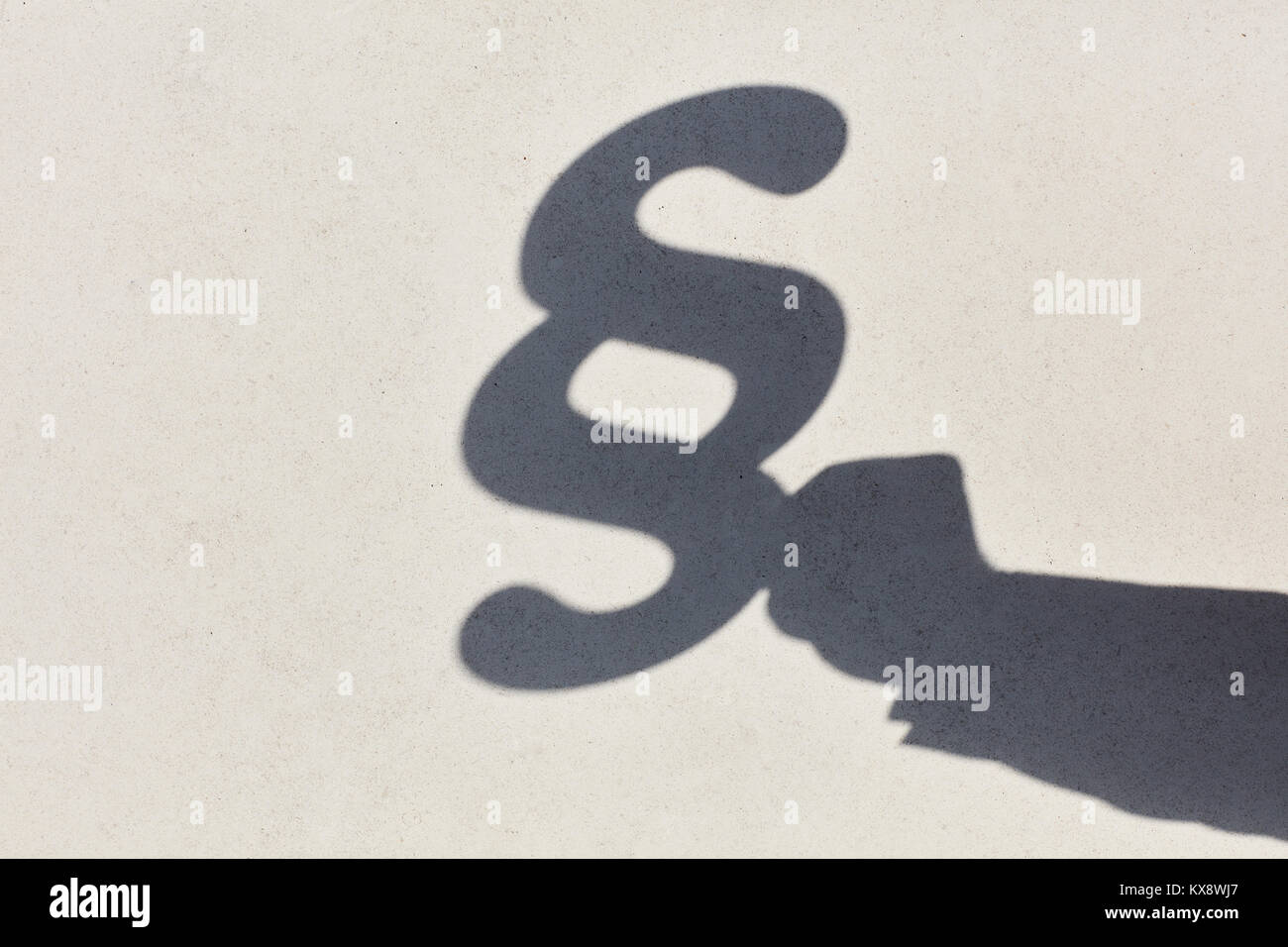 Silhouette of hand and paragraph as symbol of judgment and revision ...