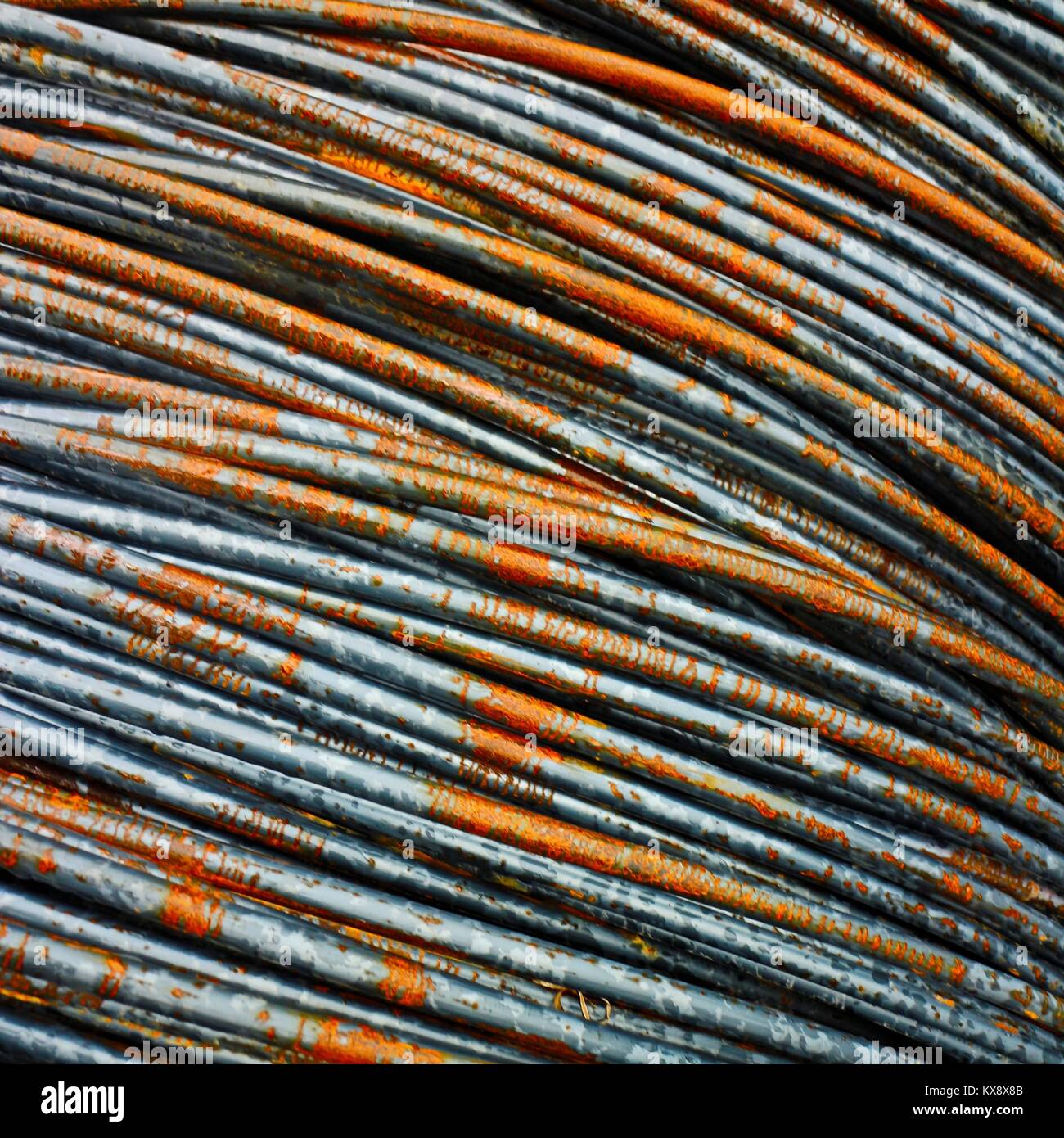 Coiled rusty steel rod wire close up Stock Photo - Alamy