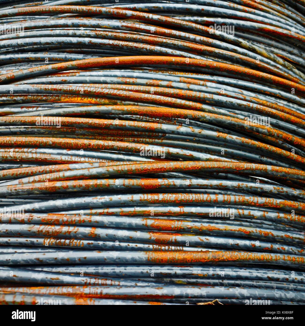 Coiled rusty steel rod wire close up Stock Photo - Alamy
