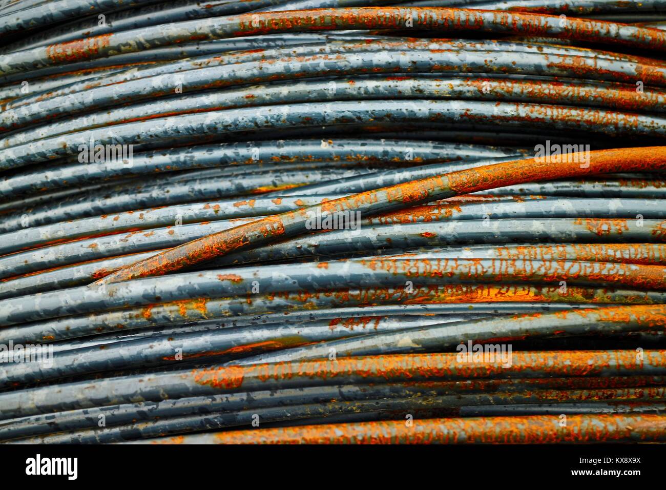 Coiled rusty steel rod wire close up Stock Photo - Alamy