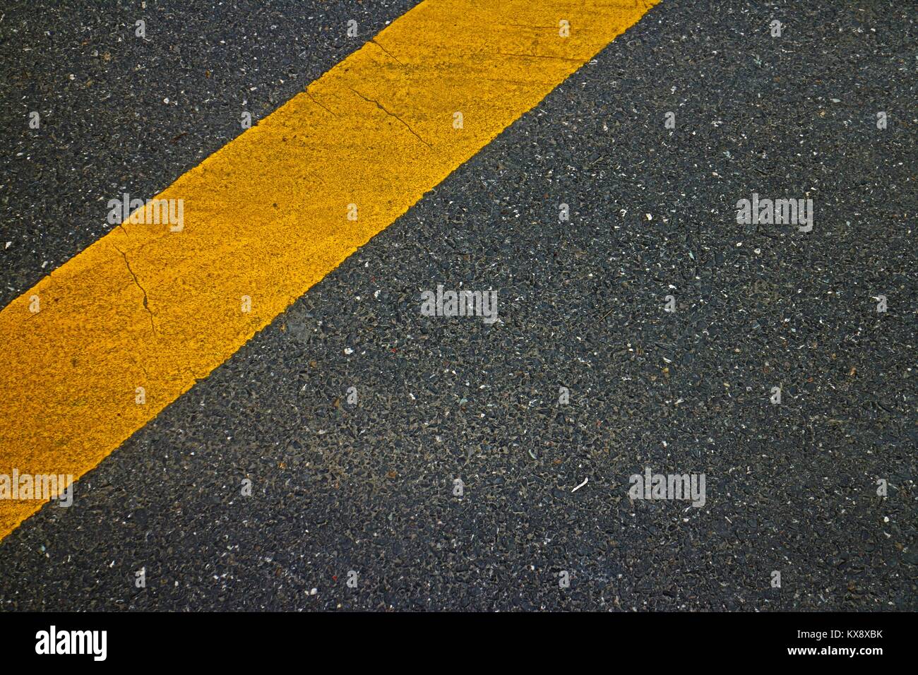 Full frame asphalt with single diagonal yellow line Stock Photo - Alamy