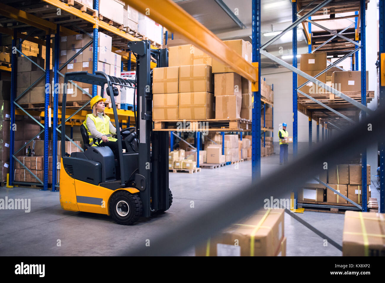 Young warehouse workers working together Stock Photo - Alamy
