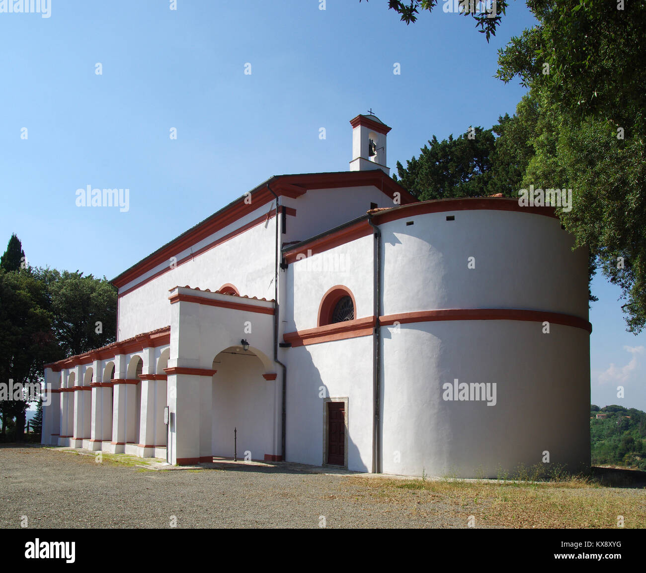 isolated white church with curved apse and red finishes in the green ...