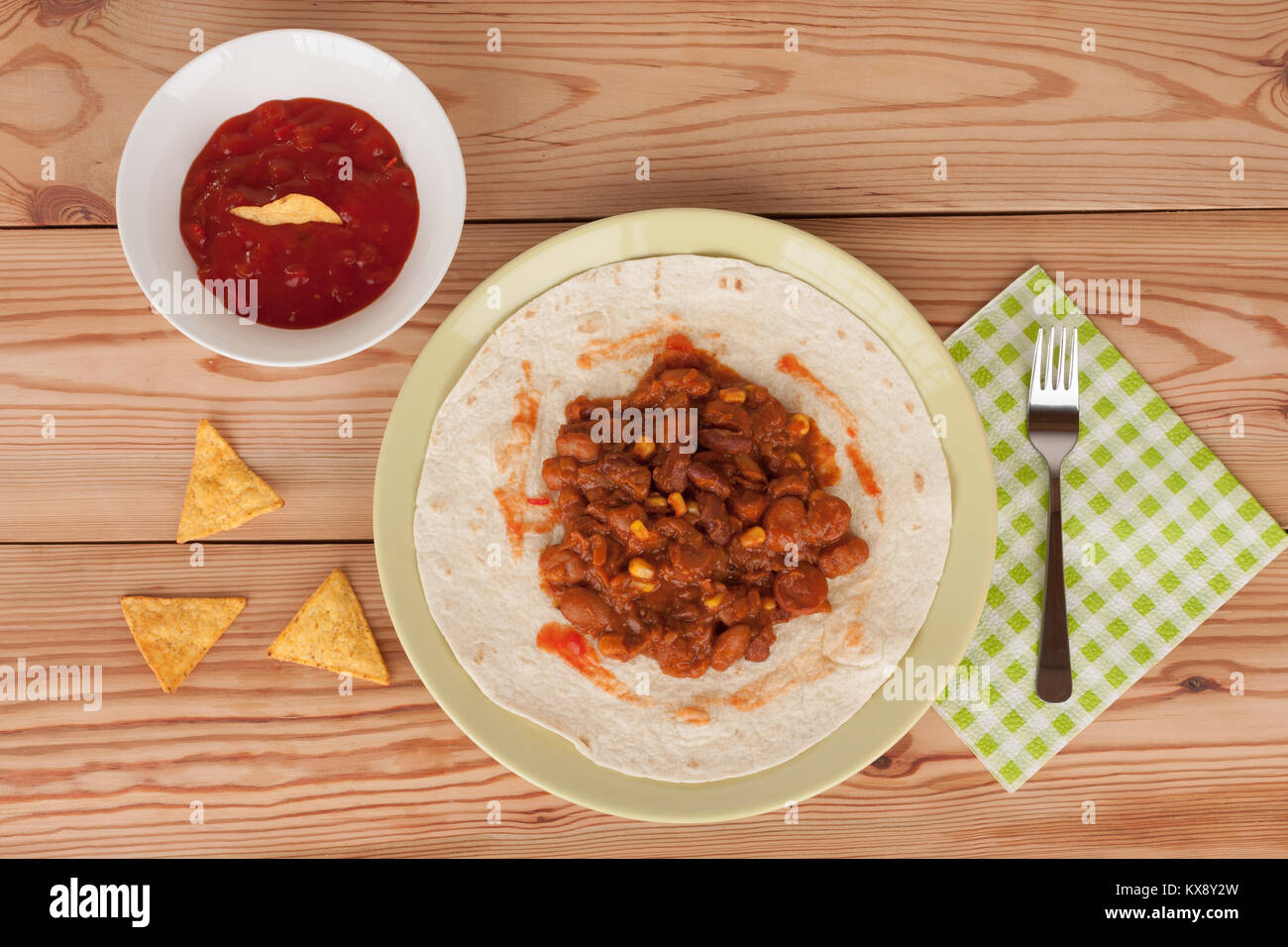 Chili Con Carne on tortilla wrap with salsa sauce and tortilla chips ...