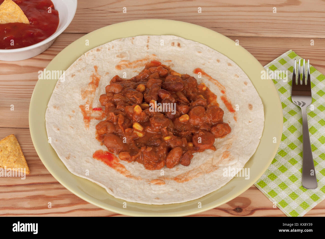 Chili Con Carne on tortilla wrap with salsa sauce and tortilla chips ...