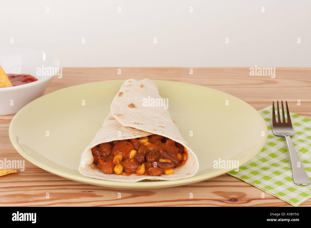 Chili Con Carne on tortilla wrap with salsa sauce and tortilla chips ...