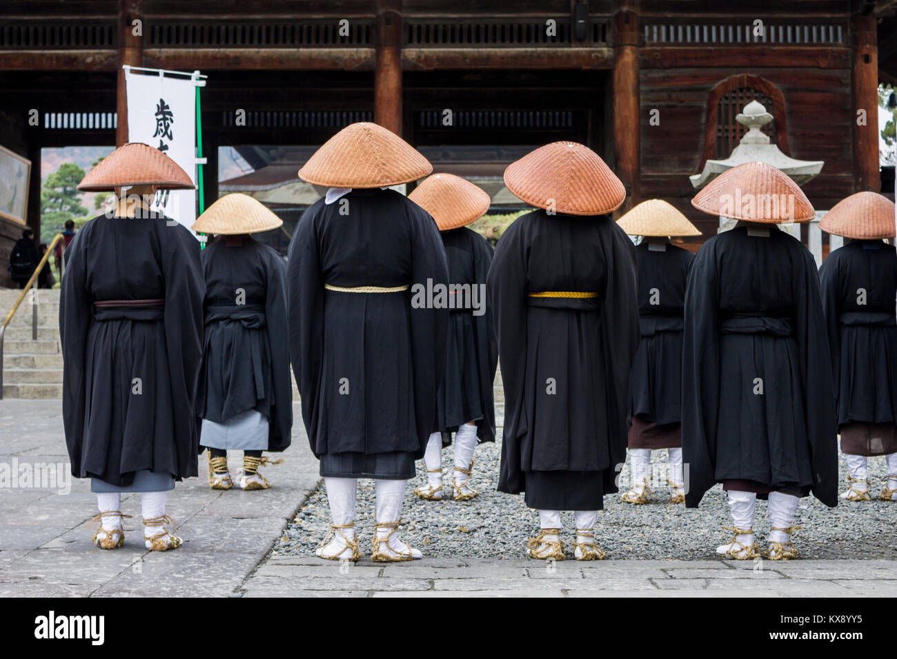 Buddhist monks looking at the Sanmon Gate in Zenko-ji, a buddhist ...