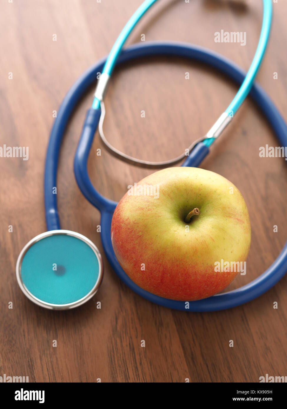 Healthy food concept with an organic apple and a stethoscope on a ...