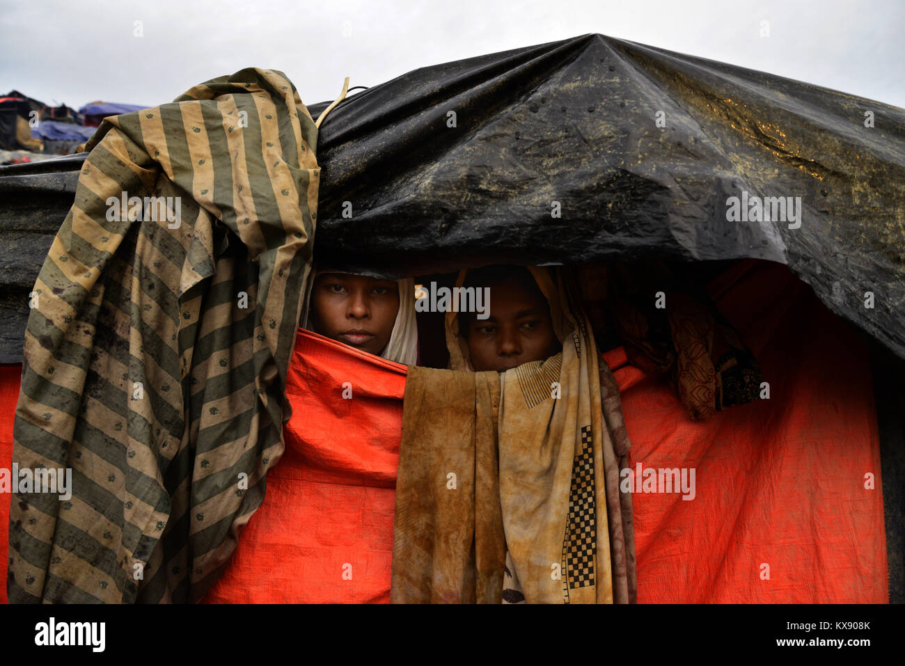 Rohingya women looks outside from their makeshift house at the ...