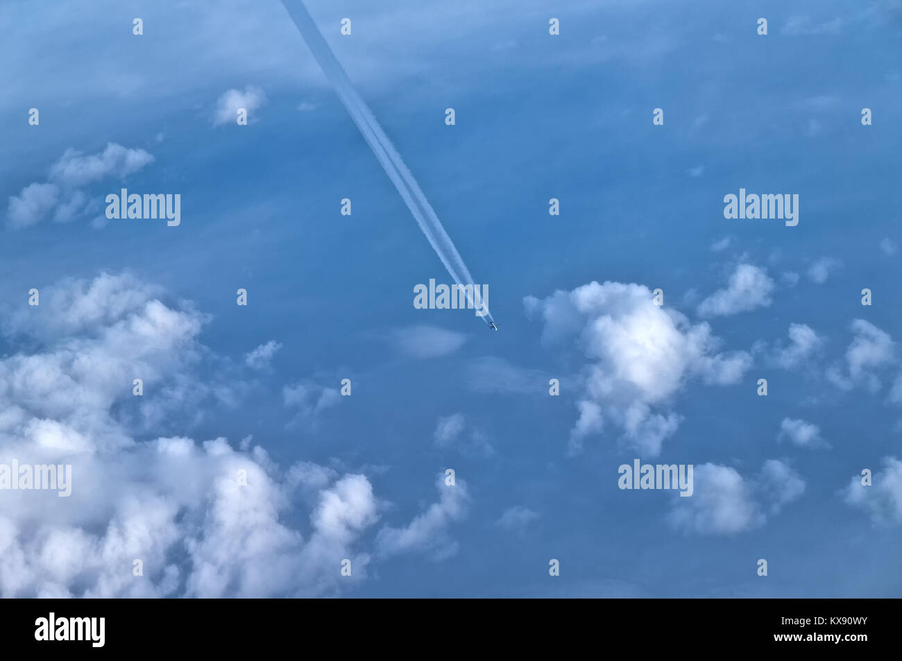 Airplane flying at high altitude near the clouds. Travel and ...