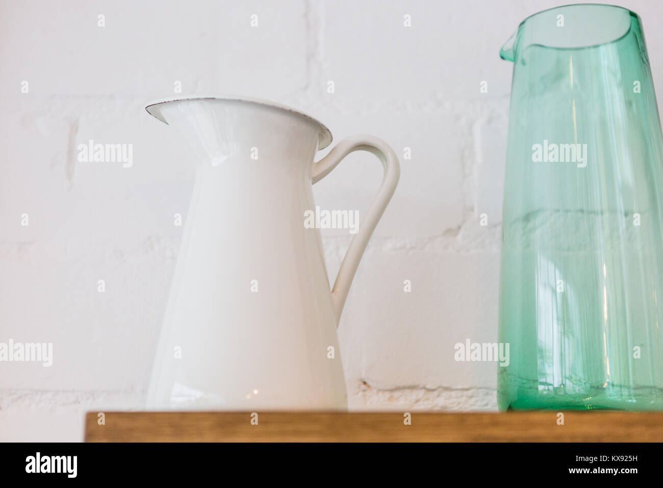 White enamel jug and glass jug on display shelf Stock Photo - Alamy