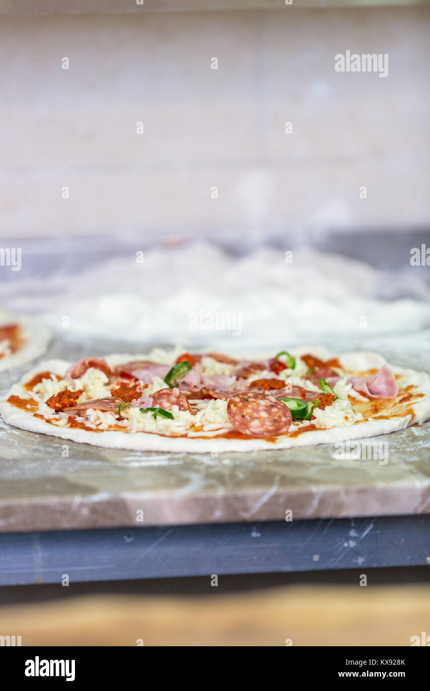 Freshly hand made pizza ready for the oven Stock Photo - Alamy