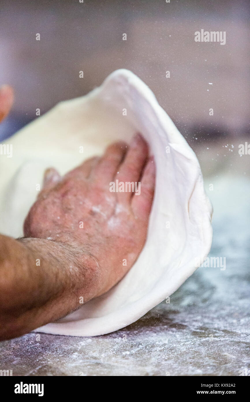 The artistry of hand crafted pizza, chef delicately stretching pizza ...